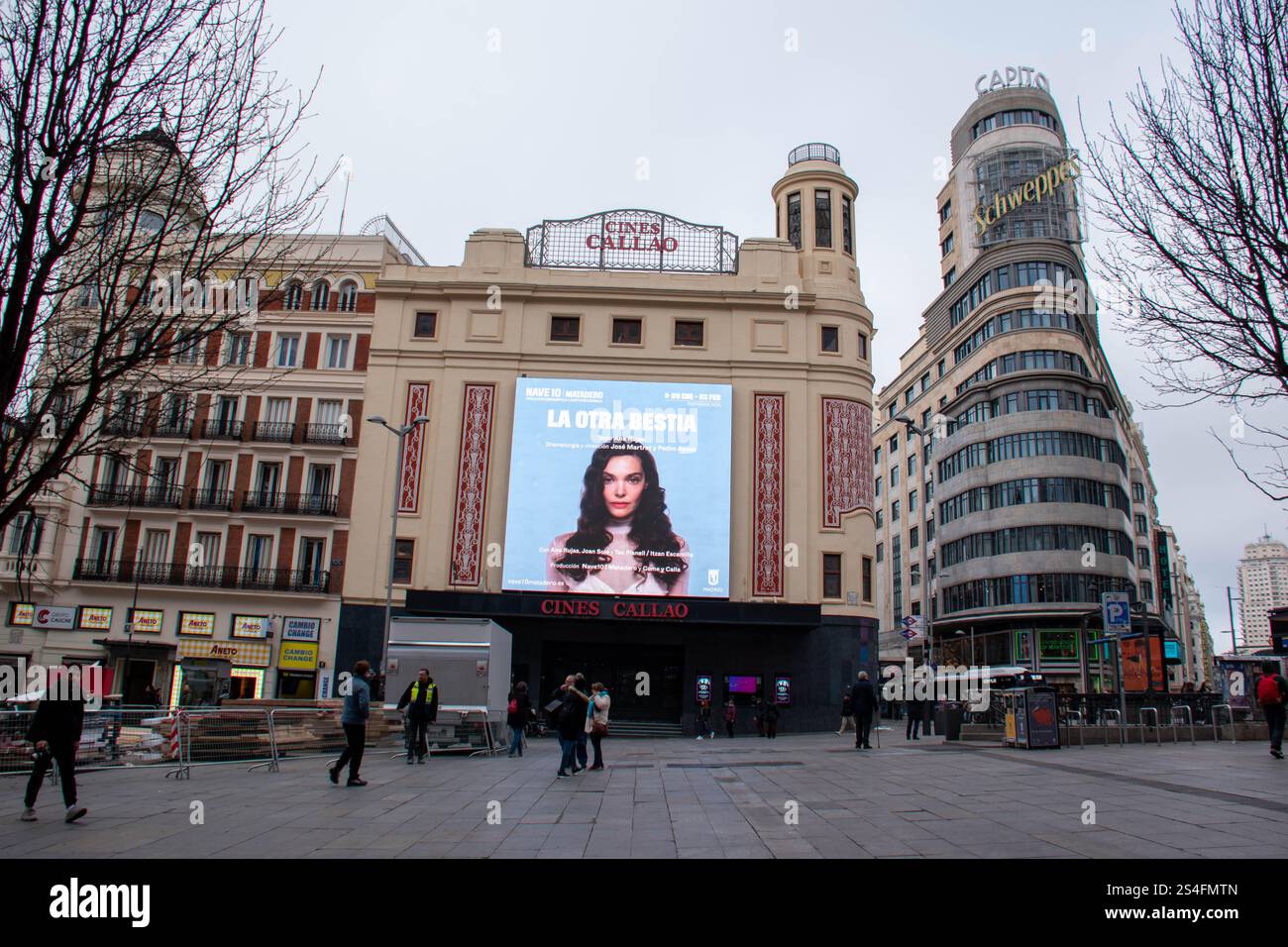 A bustling street scene in Madrid, Spain. The iconic Capitol building ...
