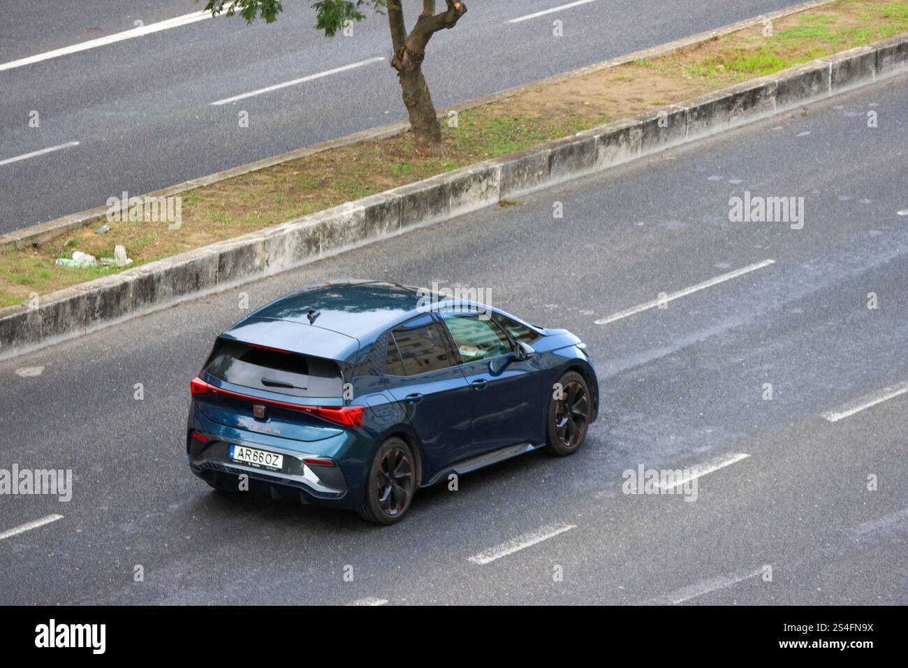 Modern electric vehicle driving on an asphalt road Stock Photo - Alamy