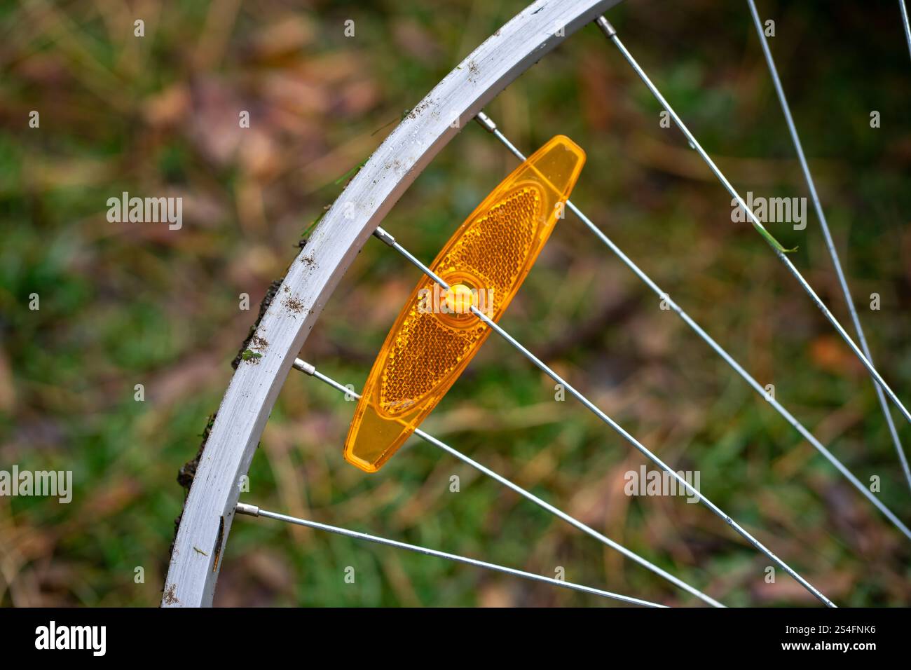 View of a broken bicycle wheel with orange warning reflector Stock ...