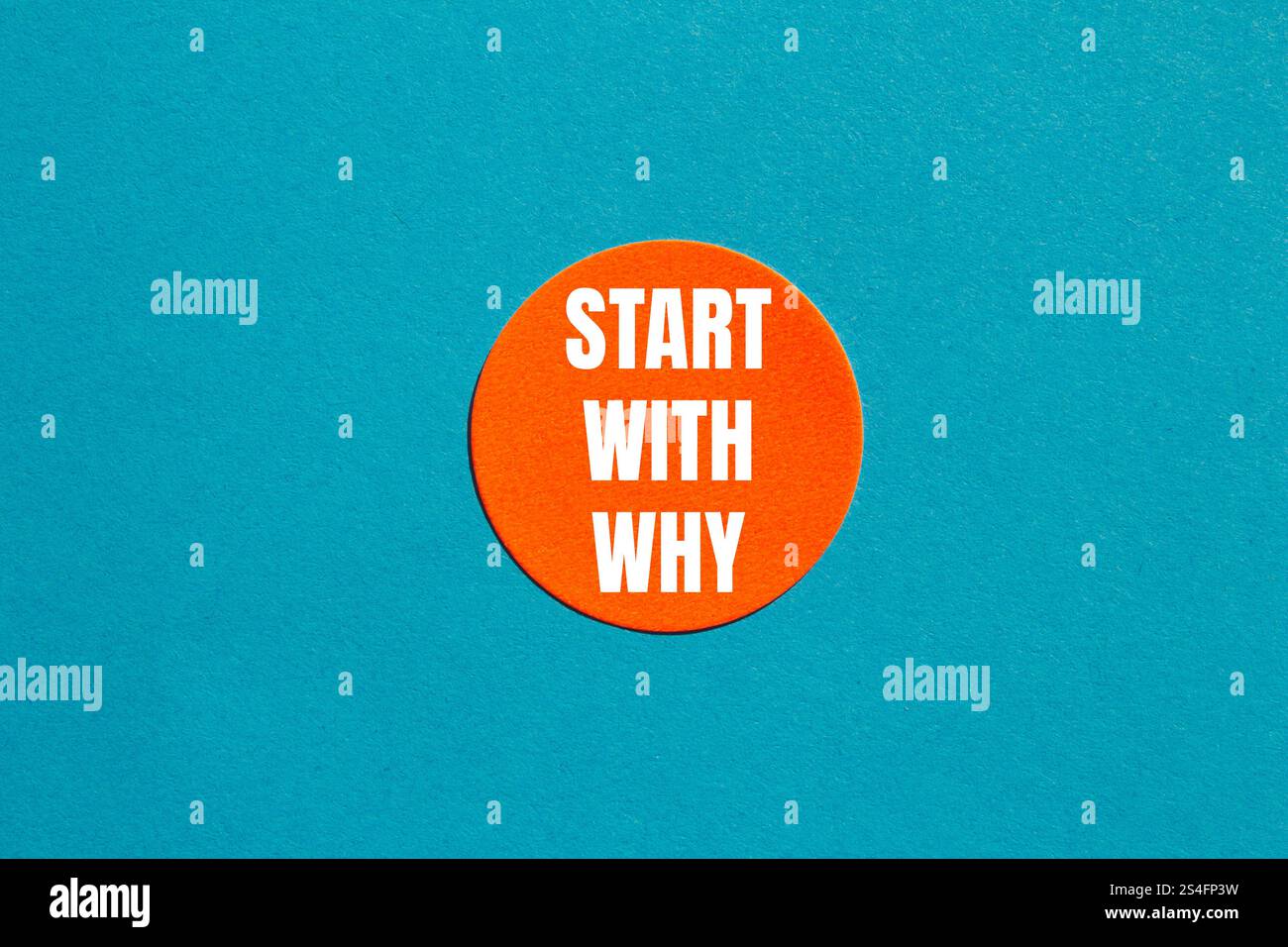 Start with why message written on round orange sticker with blue ...