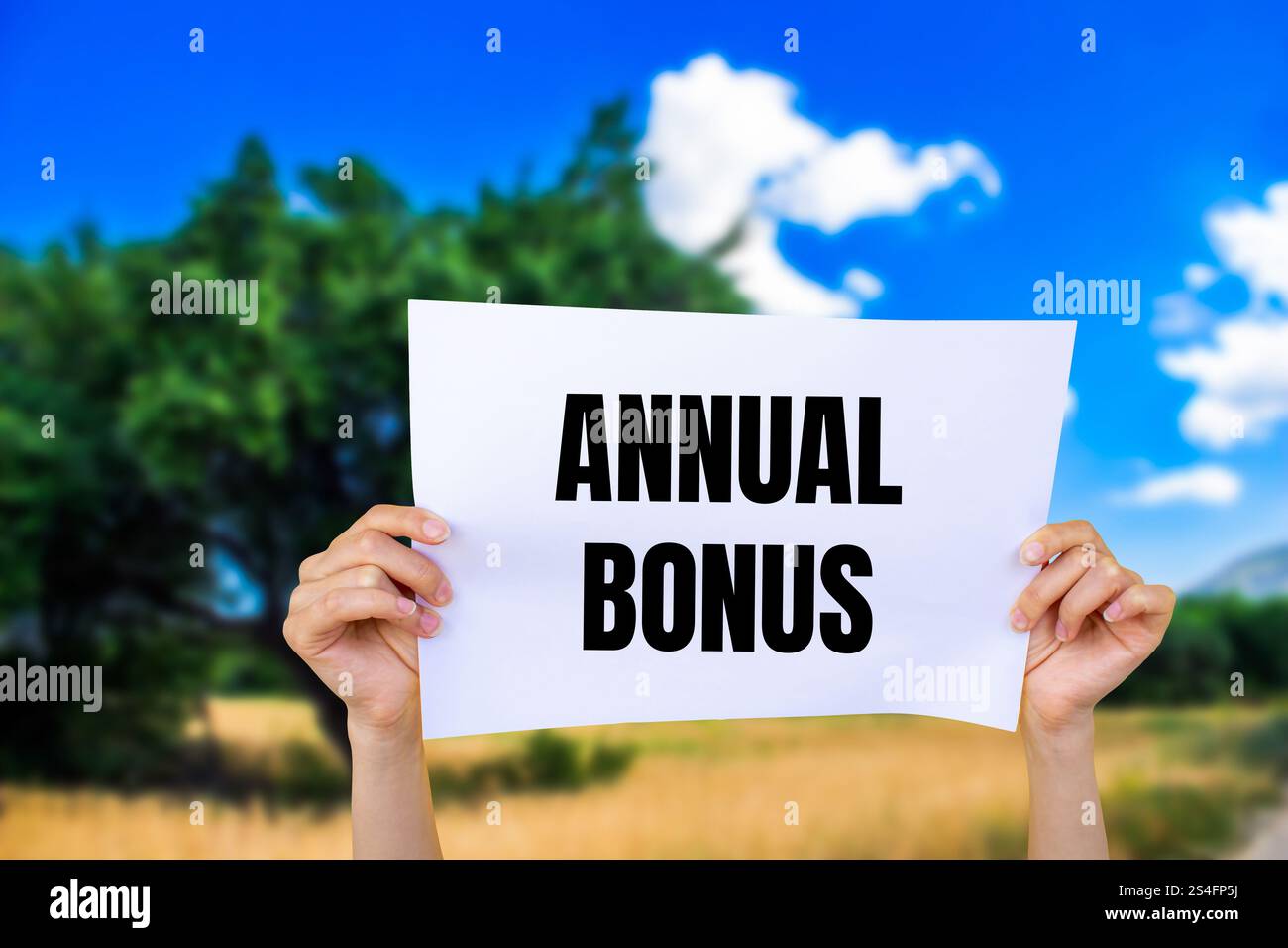Annual bonus message written on white paper with nature background ...