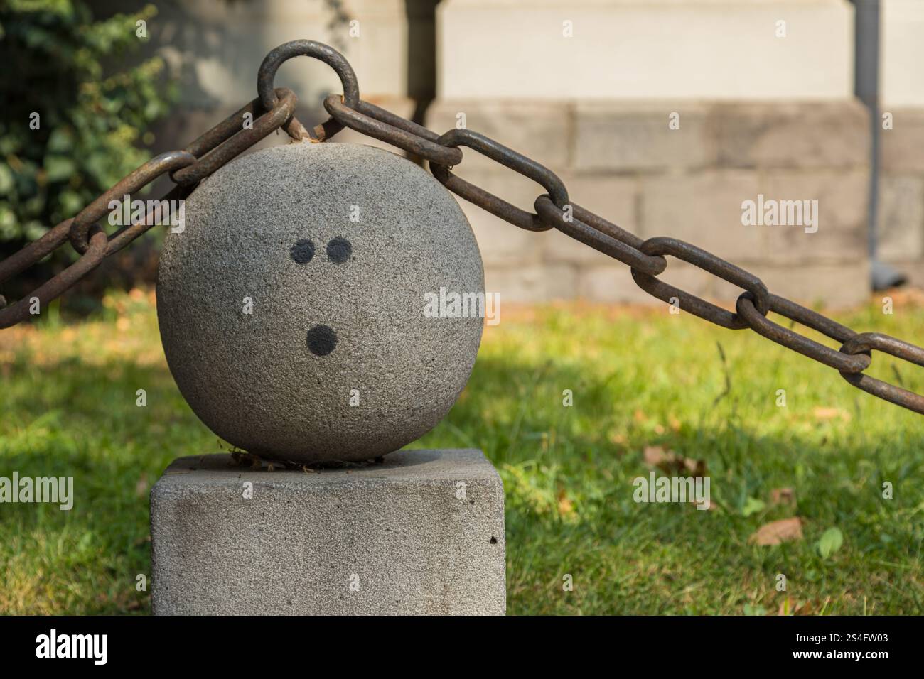Park fence. Chain with concrete elements. Smiley on a concrete ball ...