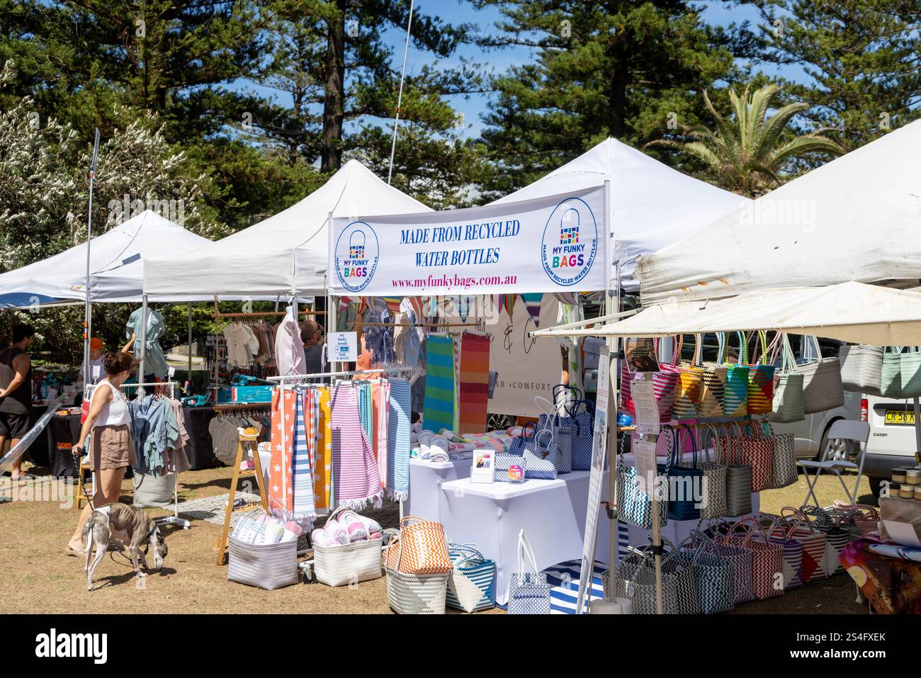 Market stall vendor selling funky bags made from recycled water bottles ...