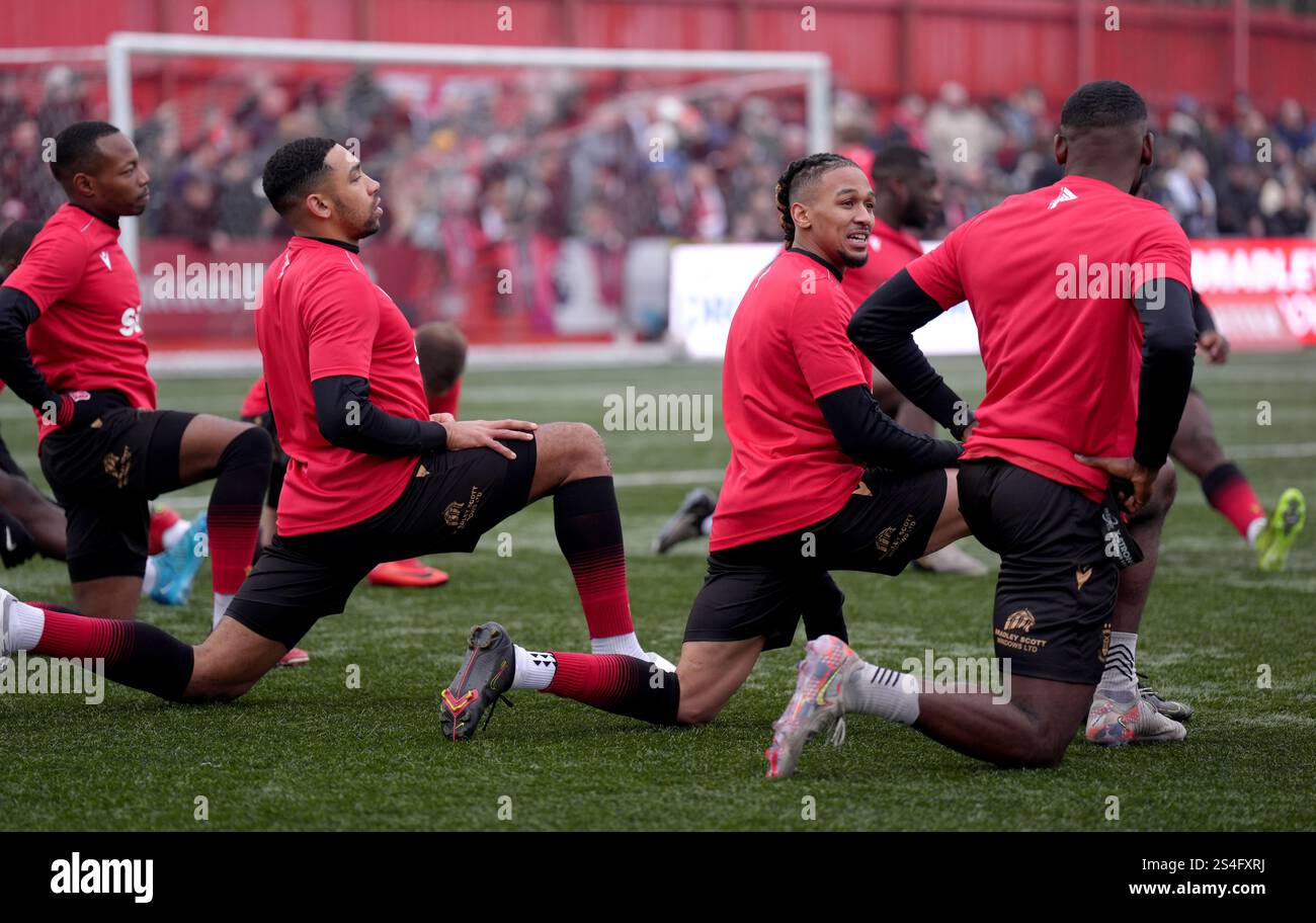 Tamworth's Kai Williams (second right) warming up before the Emirates ...
