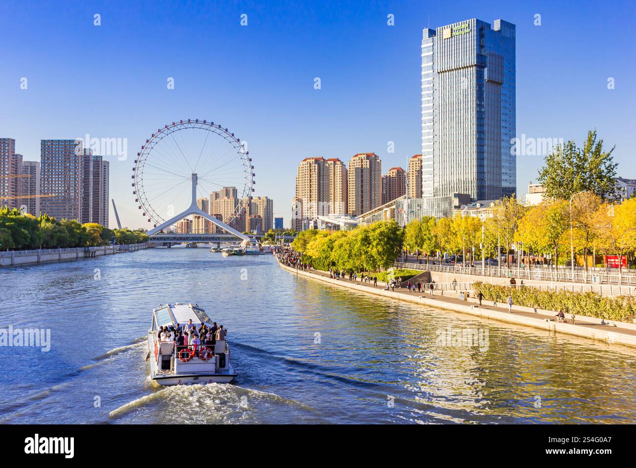 Tourists on a boat ebjoying a cruise on the Hai River in Tianjin, China ...