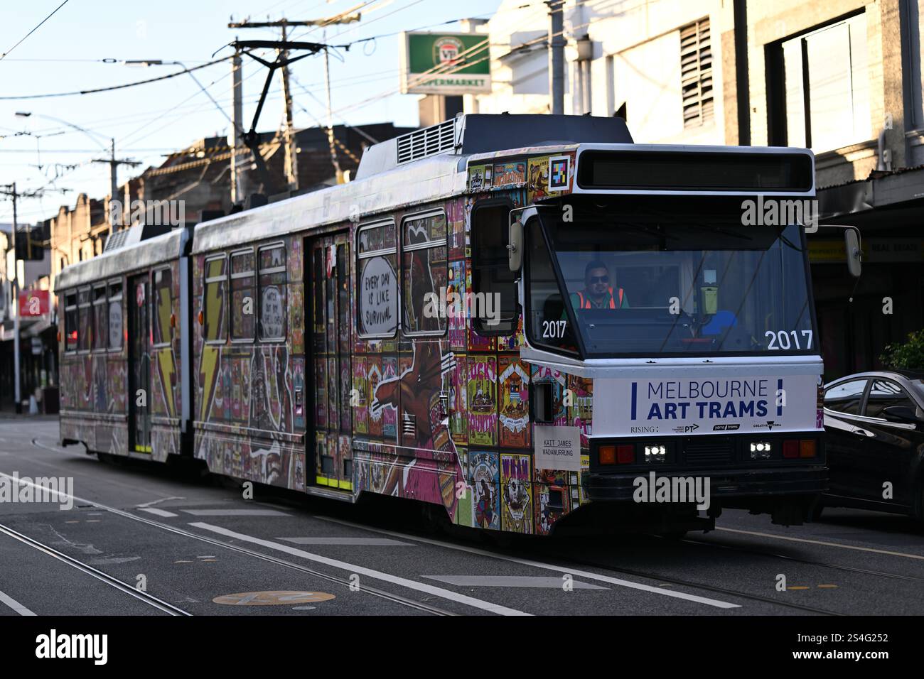 Front of a Melbourne Art Tram travelling through a suburban shopping ...