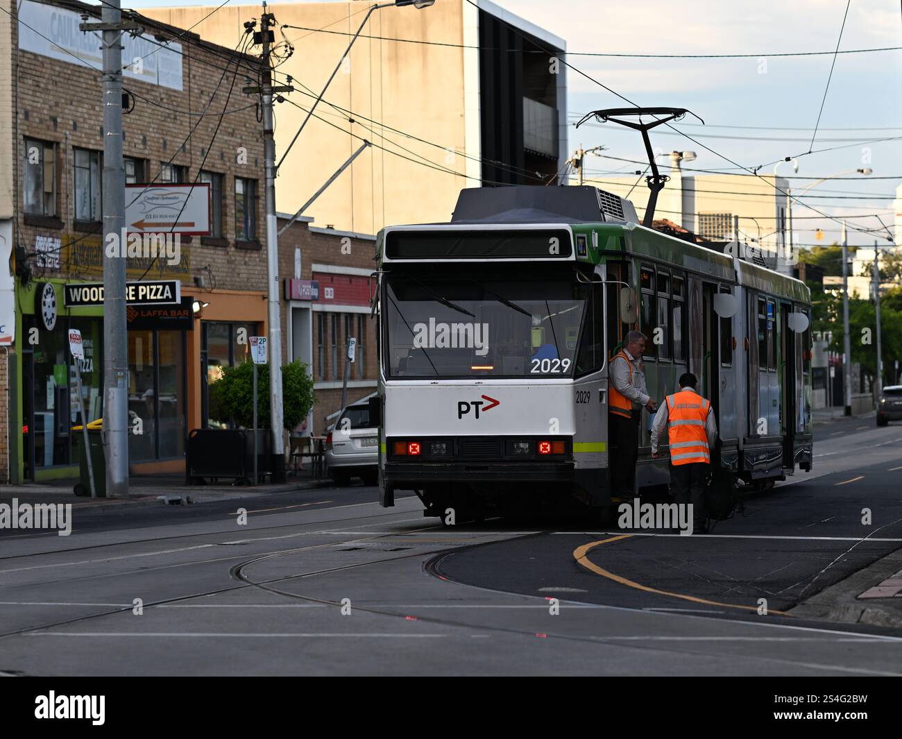 B-Class tram stopped on Hawthorn Rd in Caulfield as two drivers are mid ...