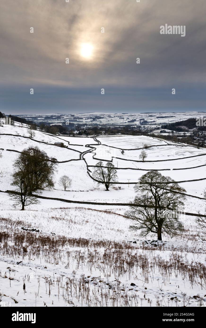 The snow-covered landscape above the village of Langcliffe near Settle ...