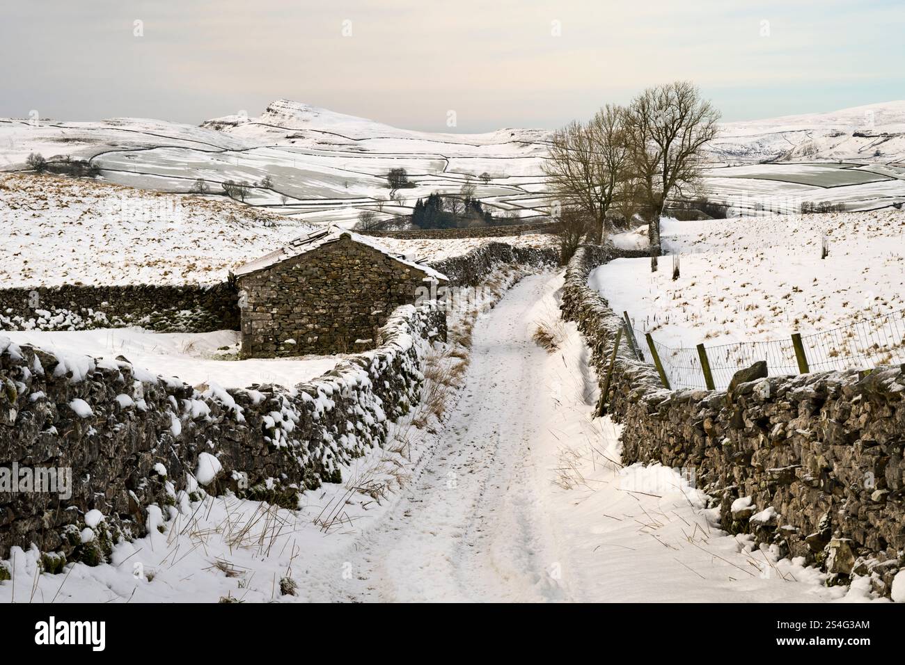 The snow-covered landscape above the village of Stainforth near Settle ...