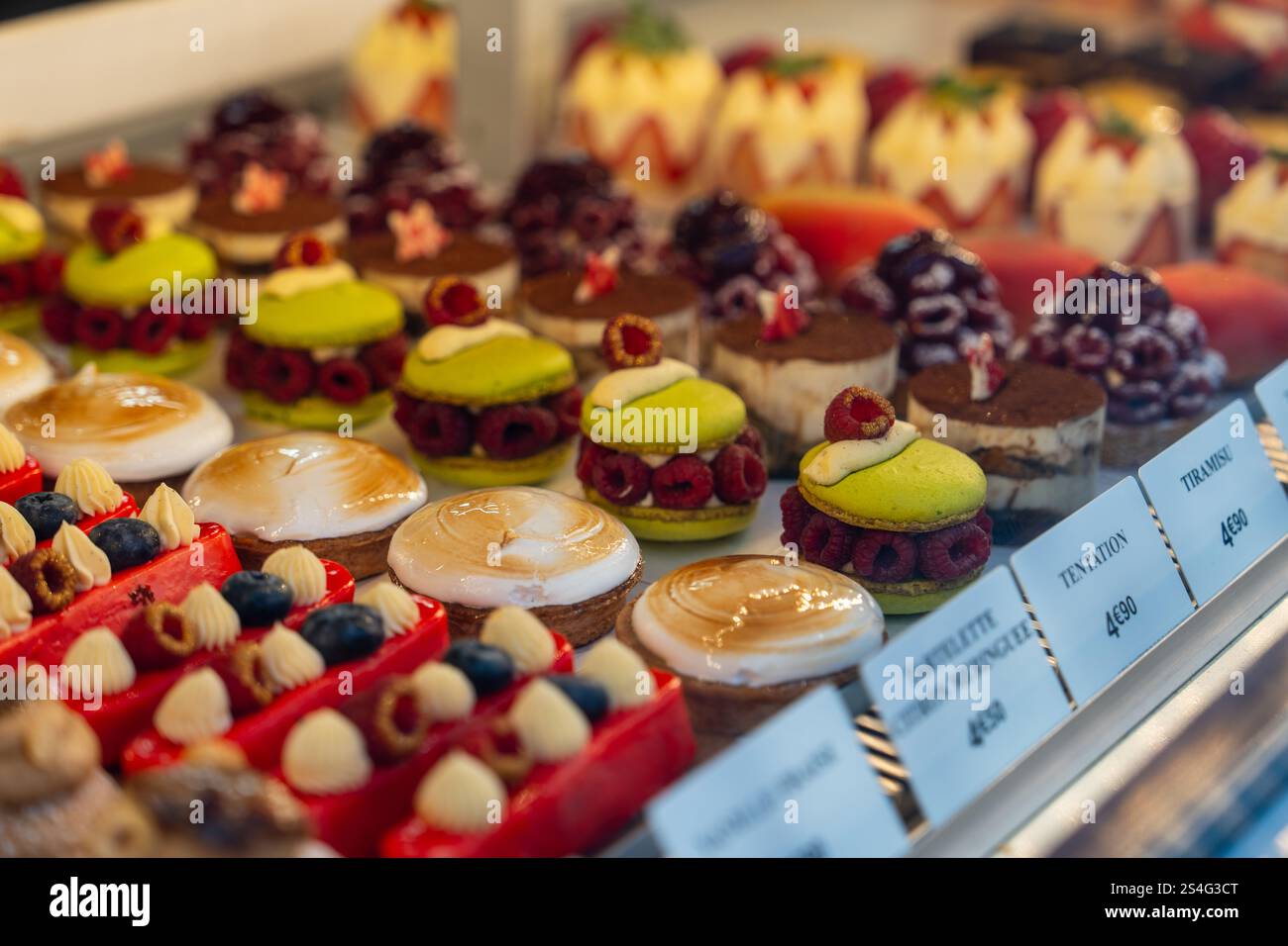 Colorful pastries displayed in a bakery case during the daytime Stock ...