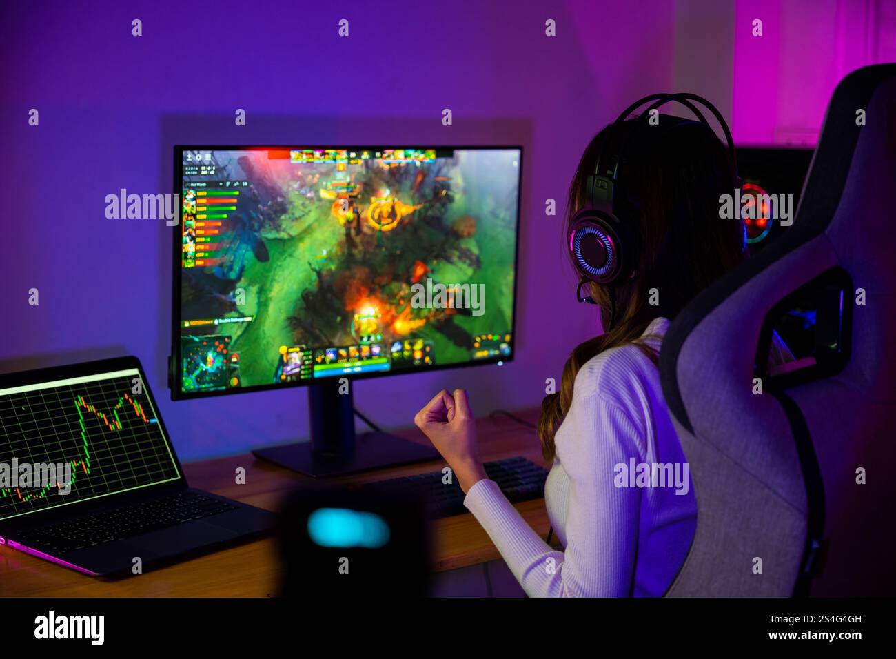 Asian gamer playing online video game excited on desktop computer PC ...