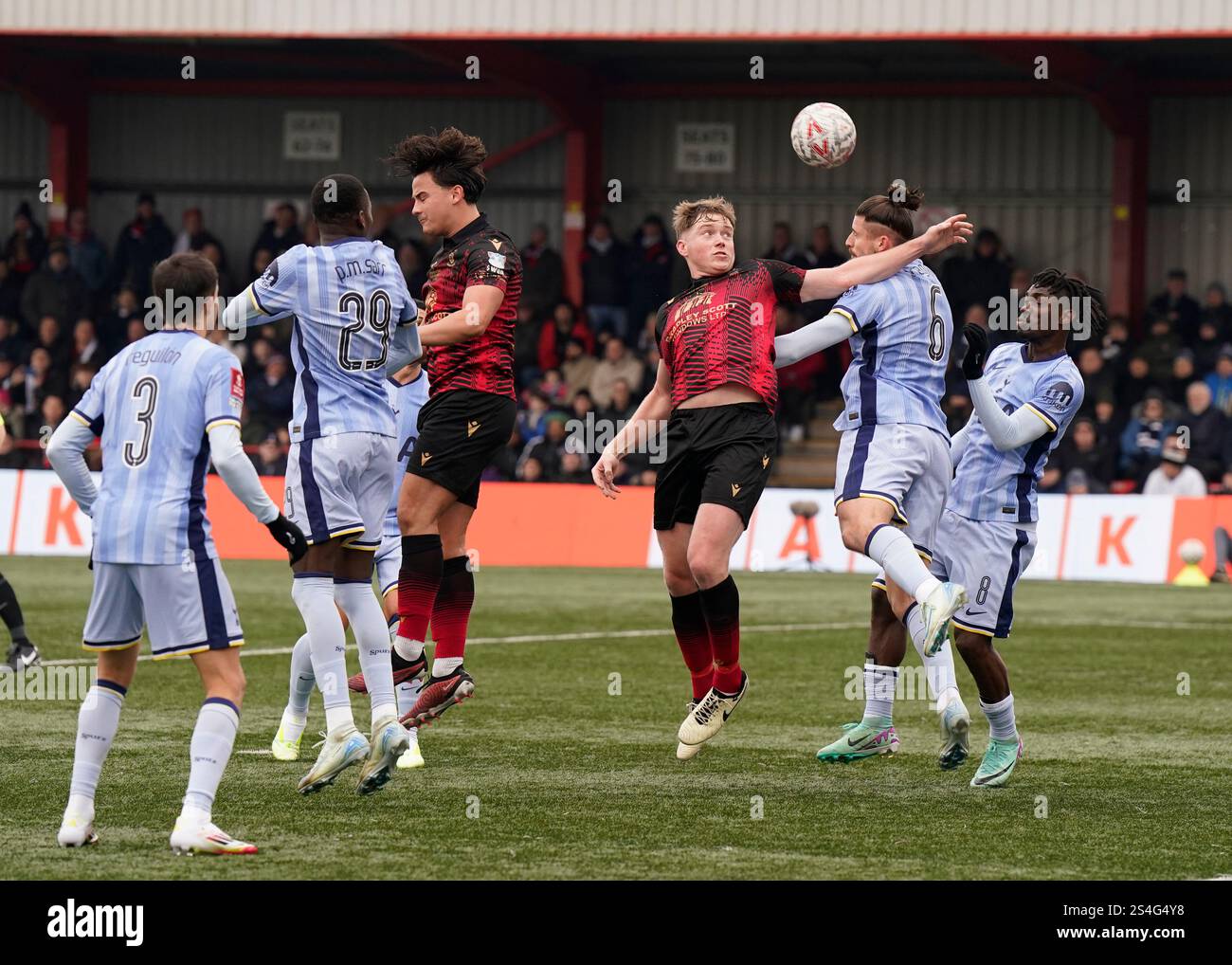 Tamworth, UK. 11th Jan, 2025. Dan Creaney of Tamworth challenges Radu ...