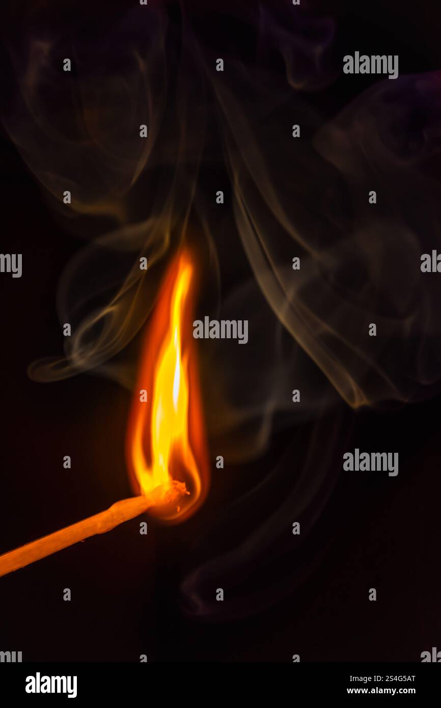burning match with some smoke on black background Stock Photo - Alamy