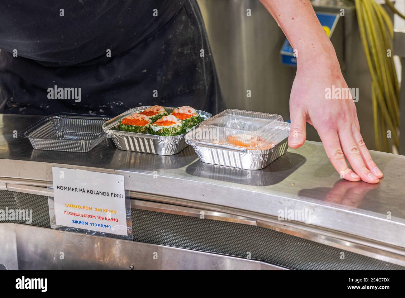 Seafood dishes in foil trays with shrimp, dill and roe on counter at ...