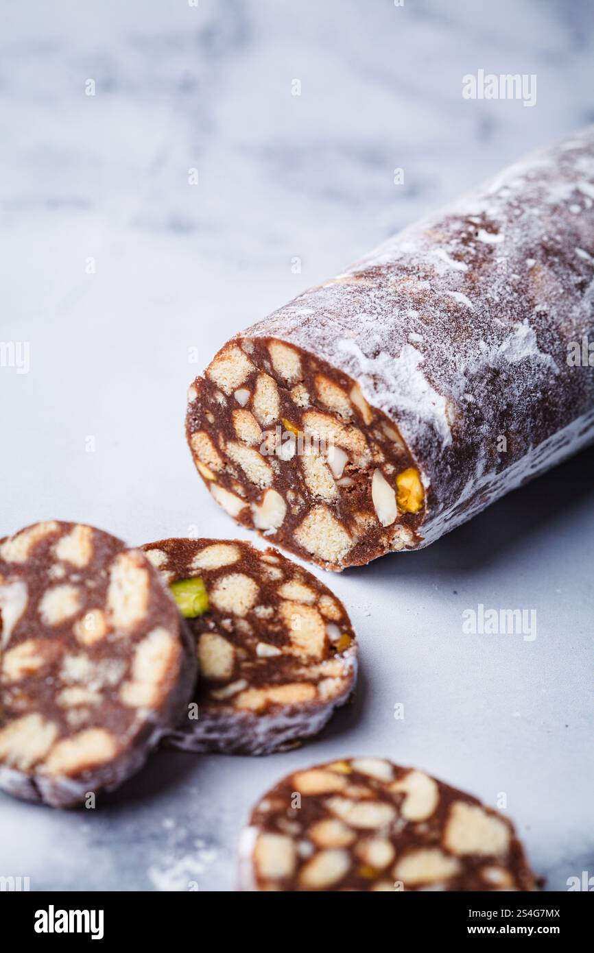Chocolate salami with nuts on a white background. Traditional Italian ...