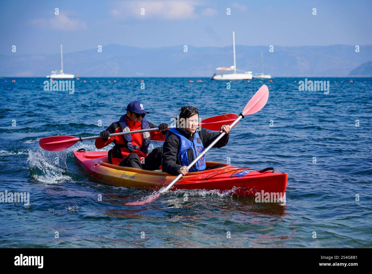 Yuxi, China's Yunnan Province. 12th Jan, 2025. A tourist (R) tries ...
