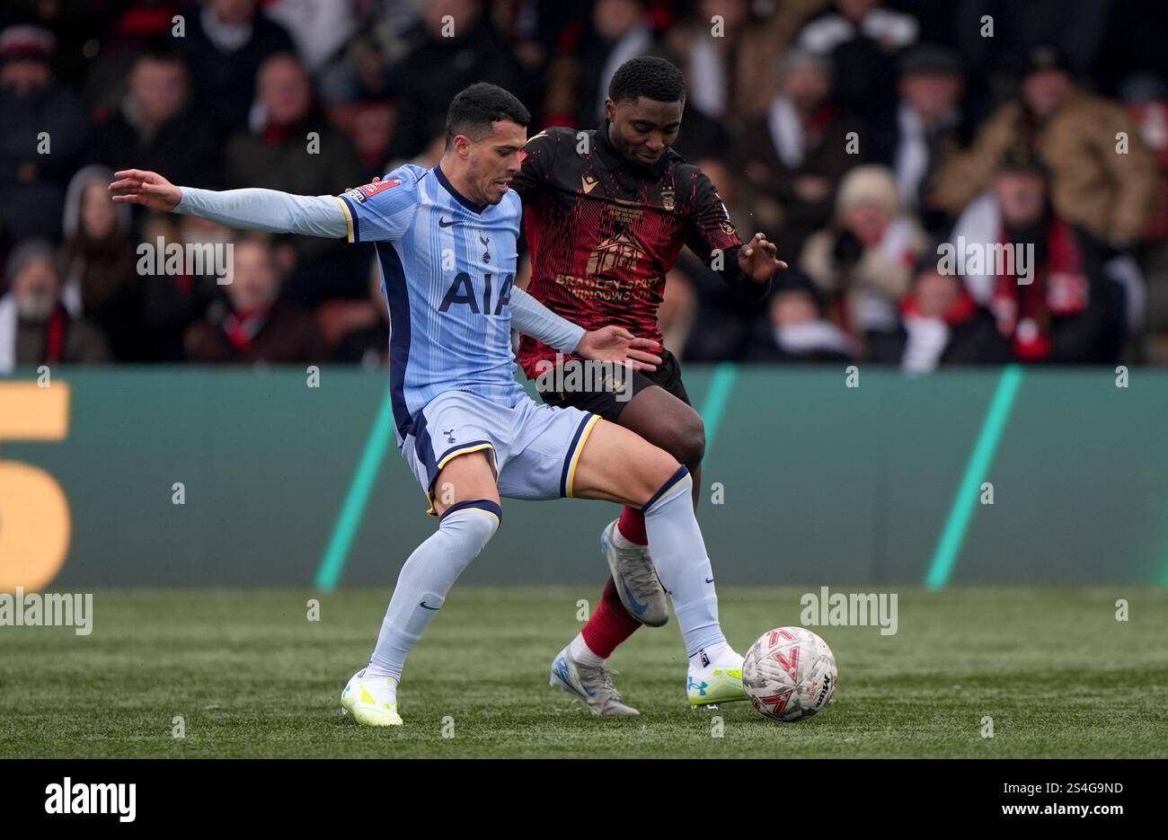 Tottenham Hotspur's Pedro Porro (left) and Tamworth's Beck-Ray Enoru ...