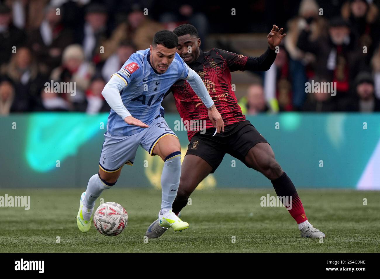 Tottenham Hotspur's Pedro Porro (left) and Tamworth's Beck-Ray Enoru ...