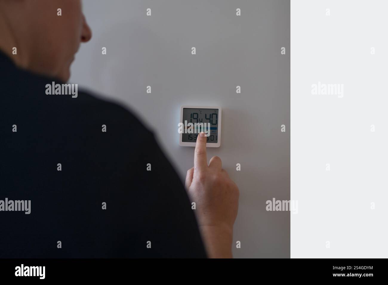 hand adjusting air conditioner button at 70 degree Fahrenheit in the ...