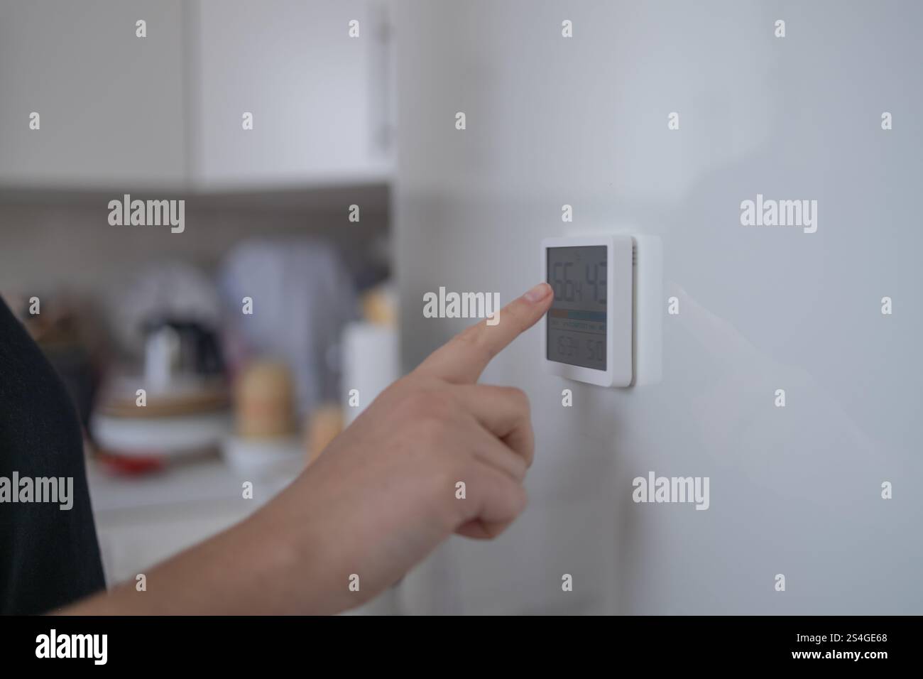 hand adjusting air conditioner button at 70 degree Fahrenheit in the ...