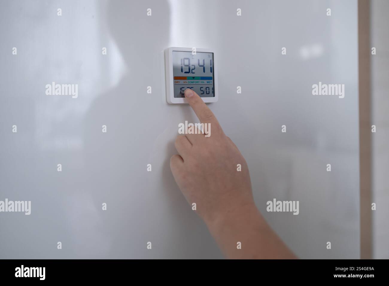 hand adjusting air conditioner button at 70 degree Fahrenheit in the ...