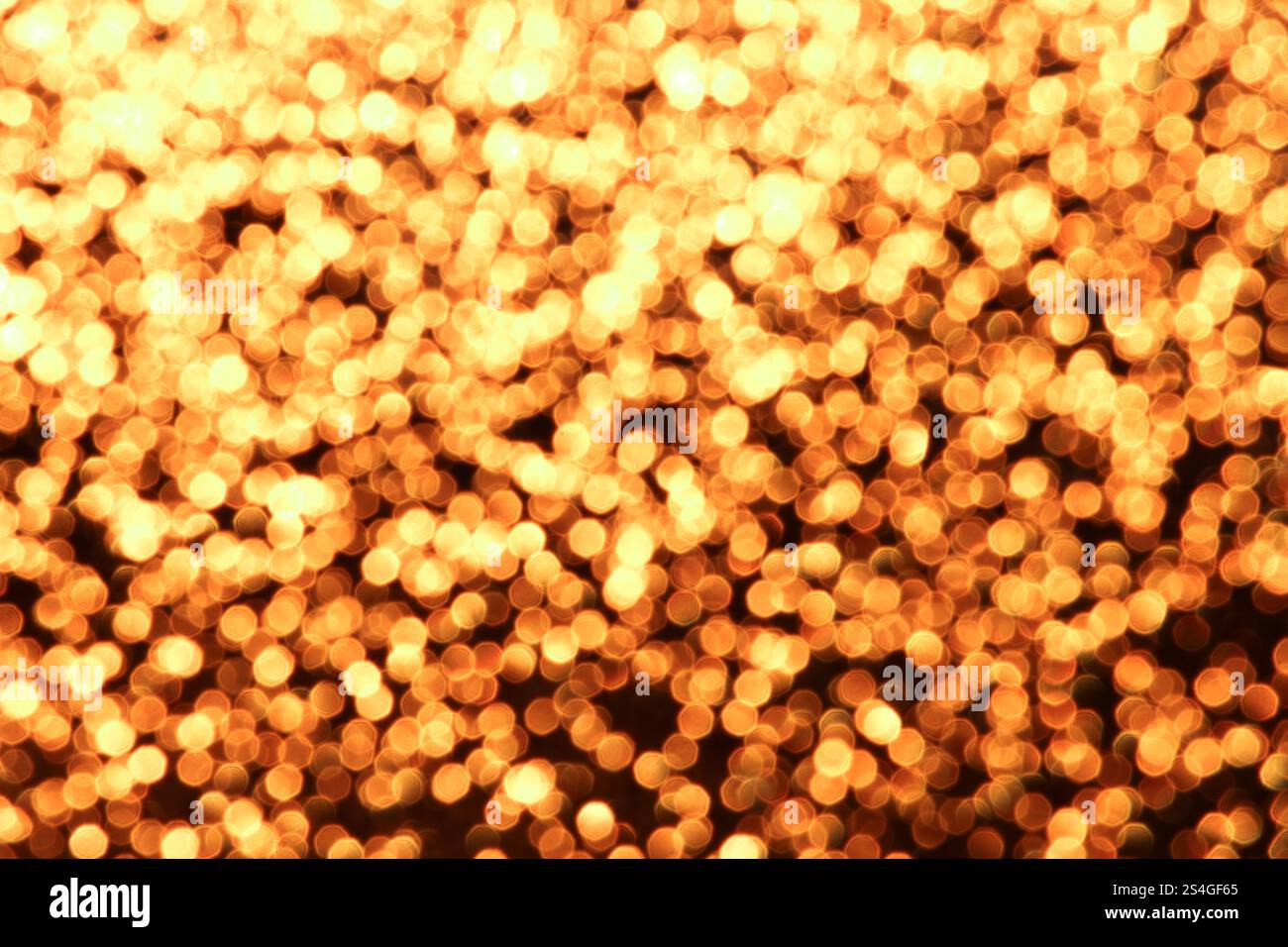 A bokeh effect photograph, out of focus lights creating a golden ...