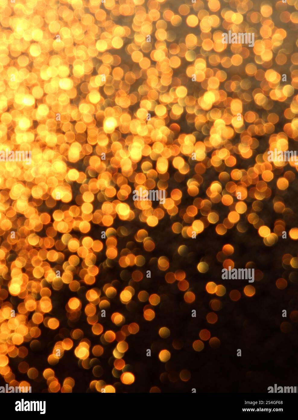 A bokeh effect photograph, out of focus lights creating a golden circles texture background ...