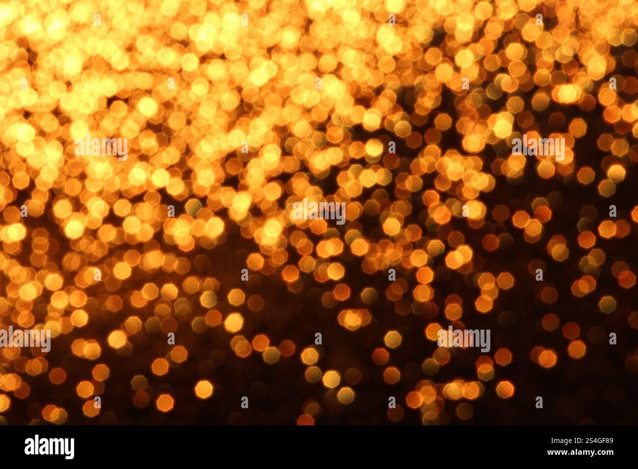 A bokeh effect photograph, out of focus lights creating a golden circles texture background ...