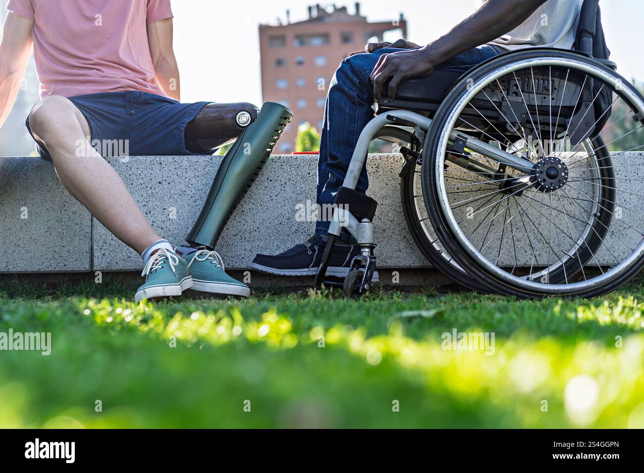 A close-up of a prosthetic leg and a wheelchair captured outdoors in a ...