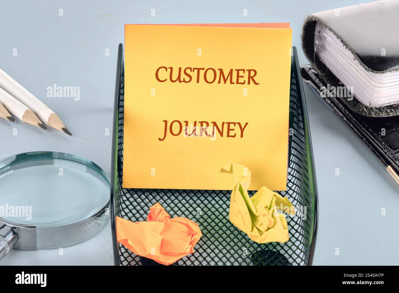 On a desk, sticky notes highlight the customer journey concept ...