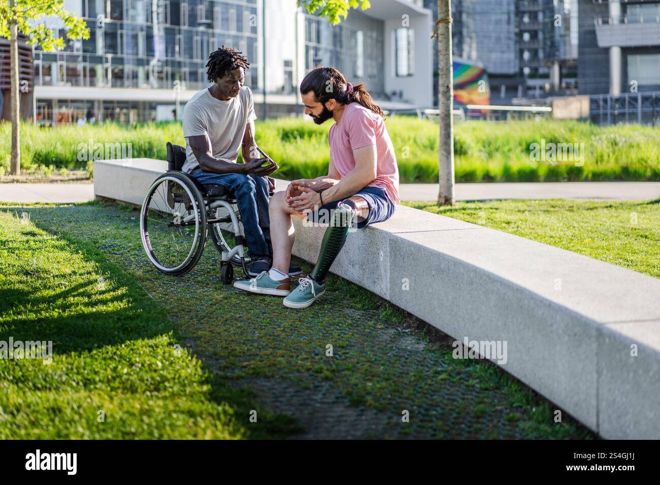 Two friends, one with a prosthetic leg and the other using a wheelchair ...