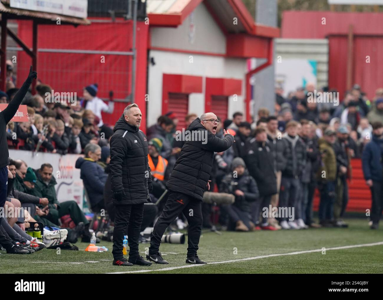 Tamworth, UK. 11th Jan, 2025. Andy Peaks manager of Tamworth (r) urges ...