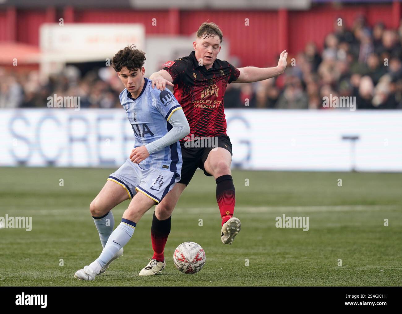 Tamworth, UK. 11th Jan, 2025. Archie Gray of Tottenham holds off Dan ...