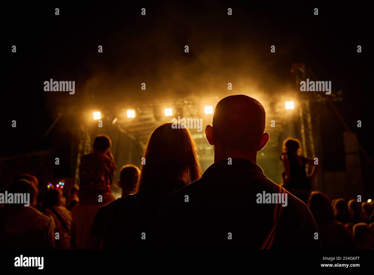 Vibrant live concert scene with band performing on stage under bright ...