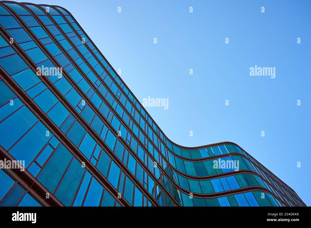 Low angle view of modern curved high rise building. Glass facade of ...