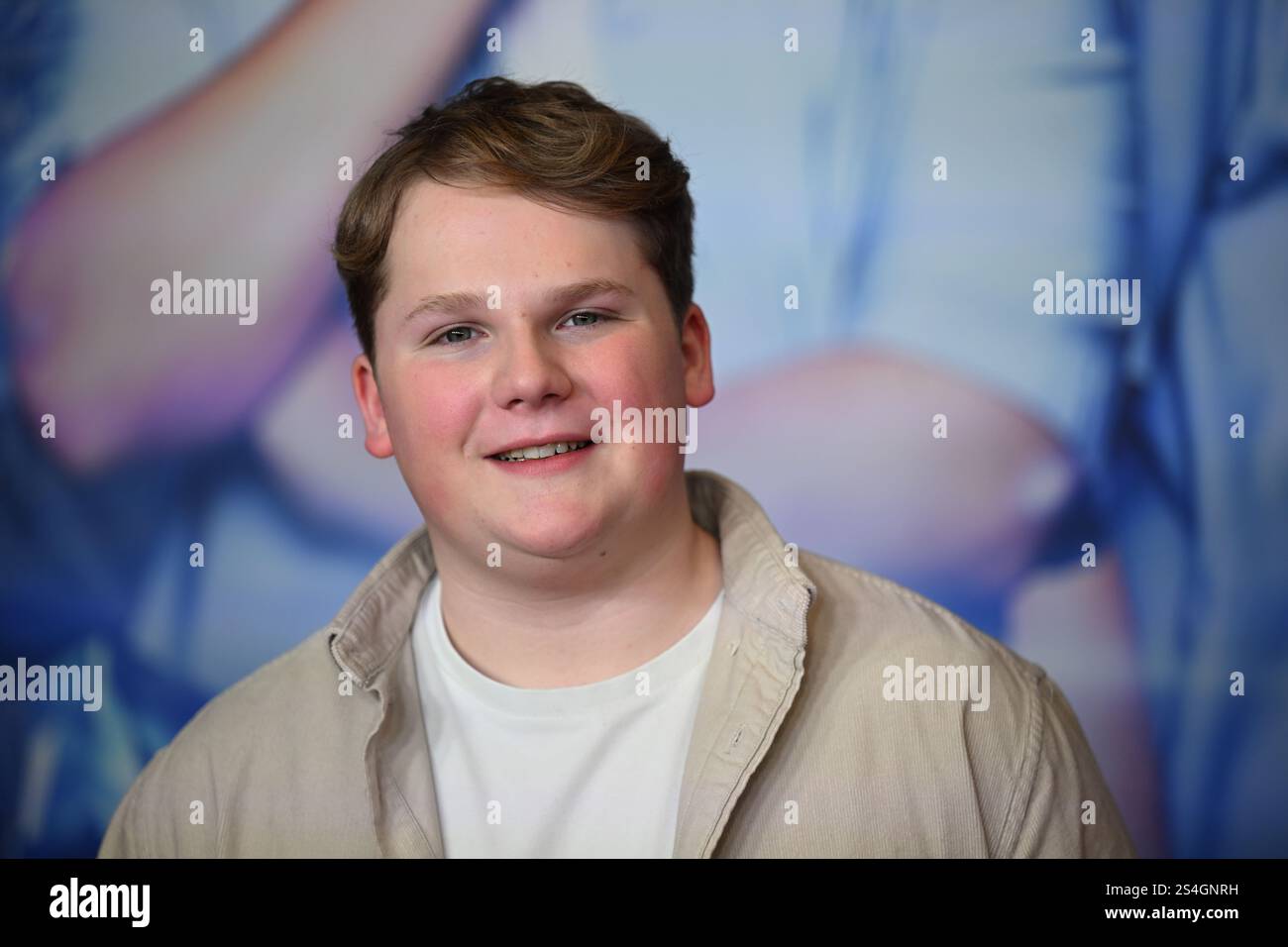 12 January 2025, Bavaria, Munich: Actor Julius Weckauf stands on the red carpet at the world ...