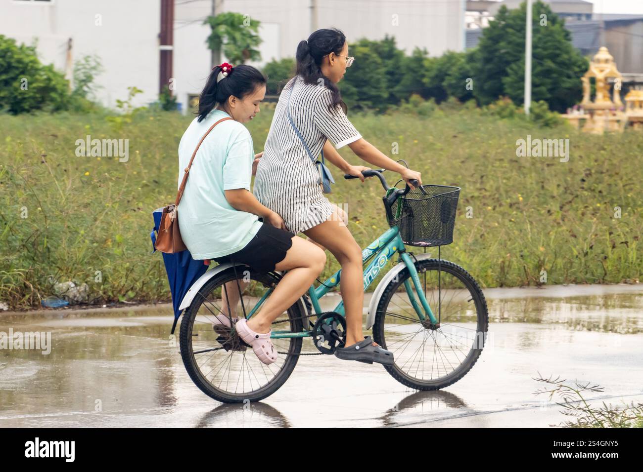 BANGKOK, THAILAND, OCT 06 2024, A couple is riding a bicycle together ...