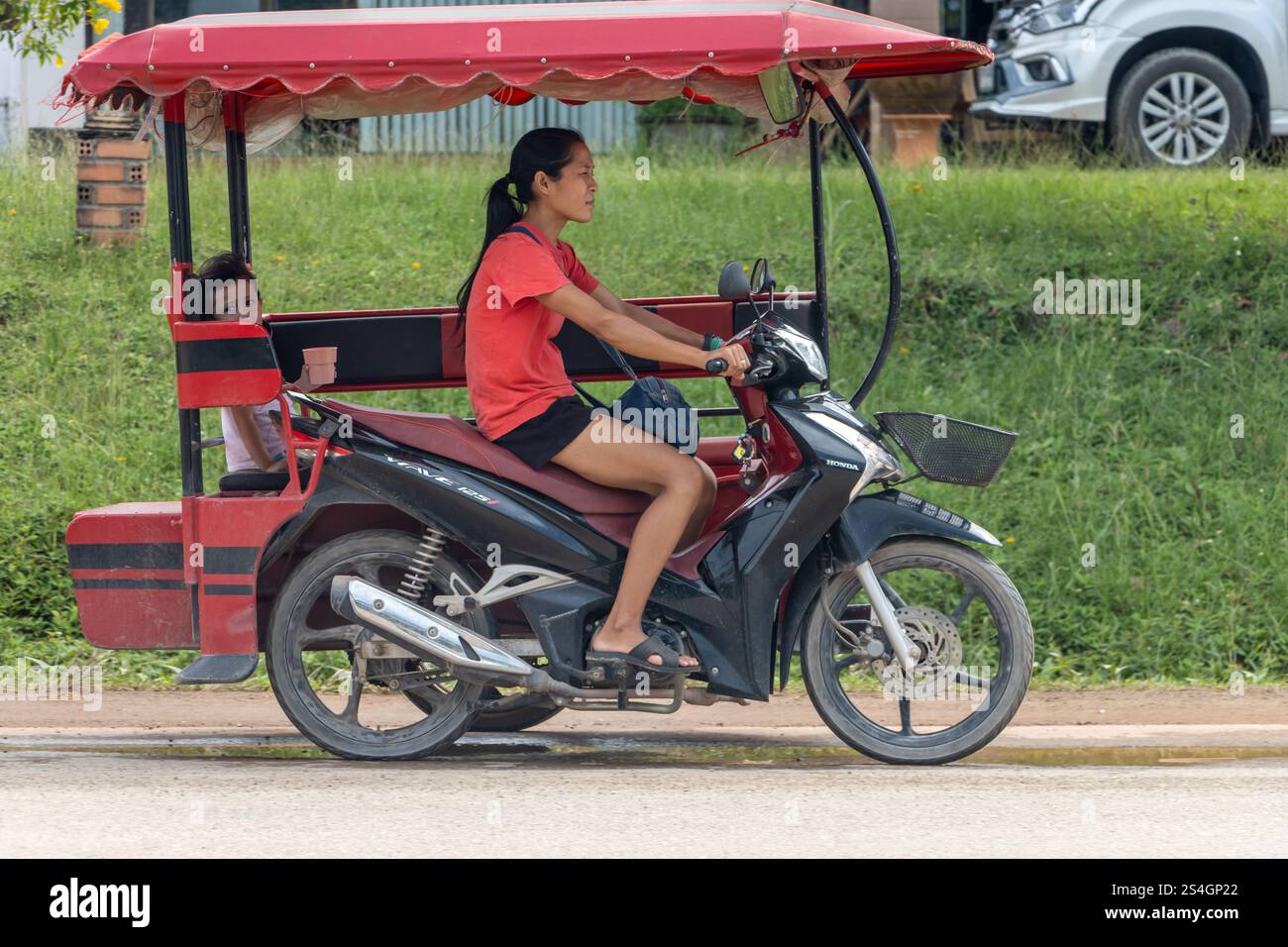 KOH LANTA, THAILAND, DEC 01 2024, Woman driving a motorcycle with a ...