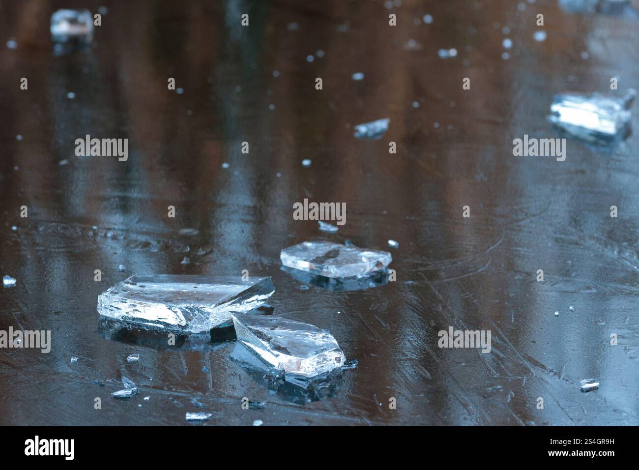 Ice fragments on surface of frozen lake broken abstract shapes clear ...