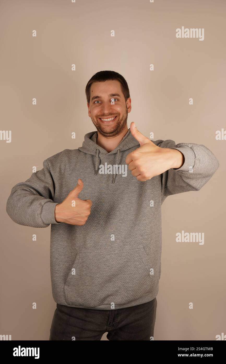 The guy has a small beard and a short haircut. The smile conveys a ...