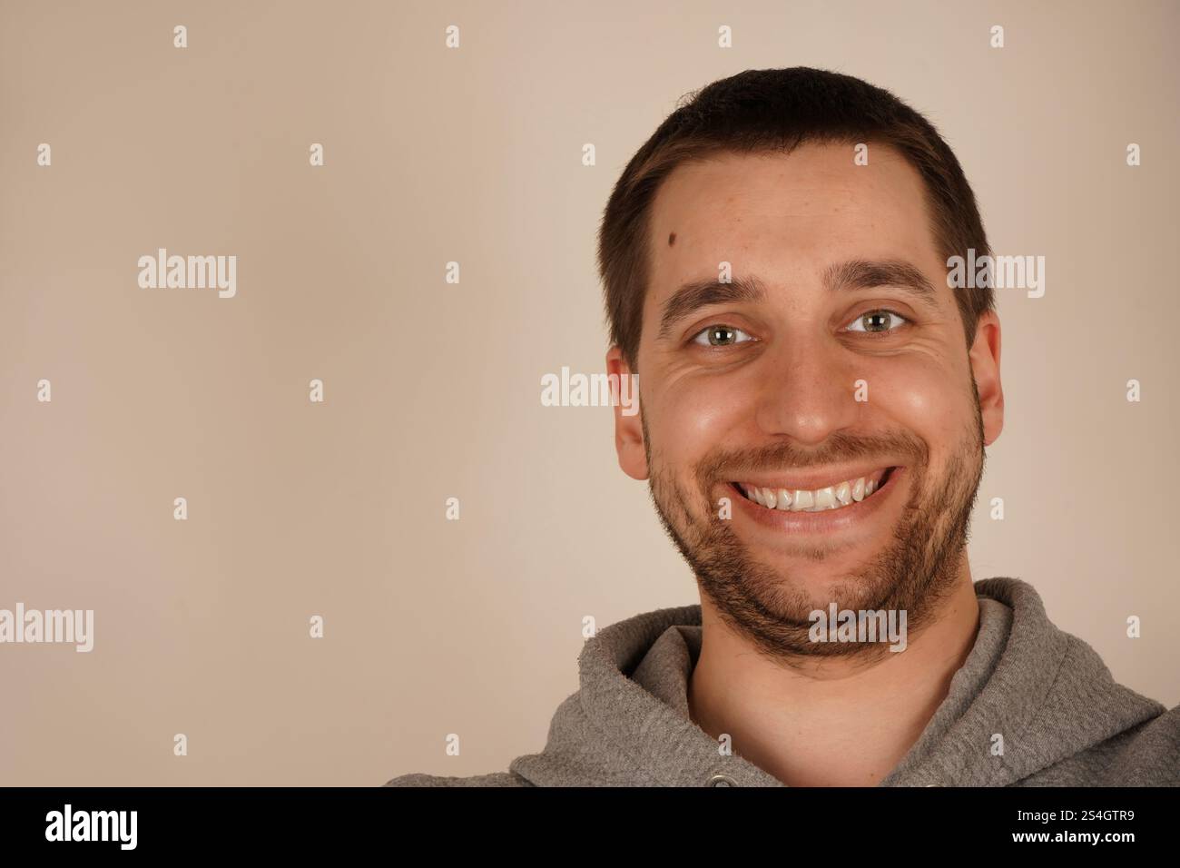 The face of a man smiling broadly in positive emotions. The guy has a ...