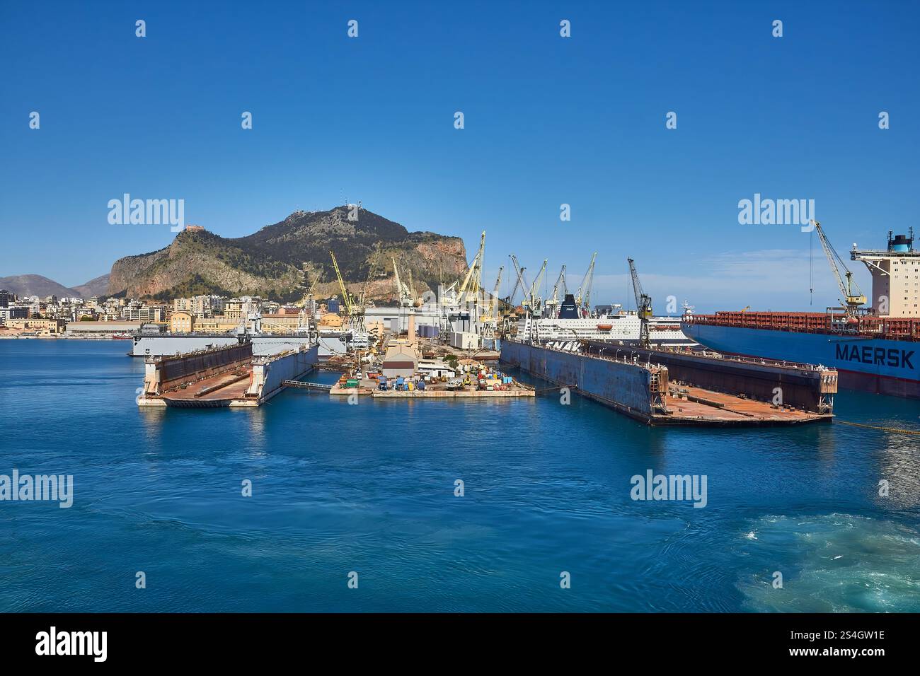 Palermo Shipyard and drydock with clear sky, blue water, cranes, docks ...