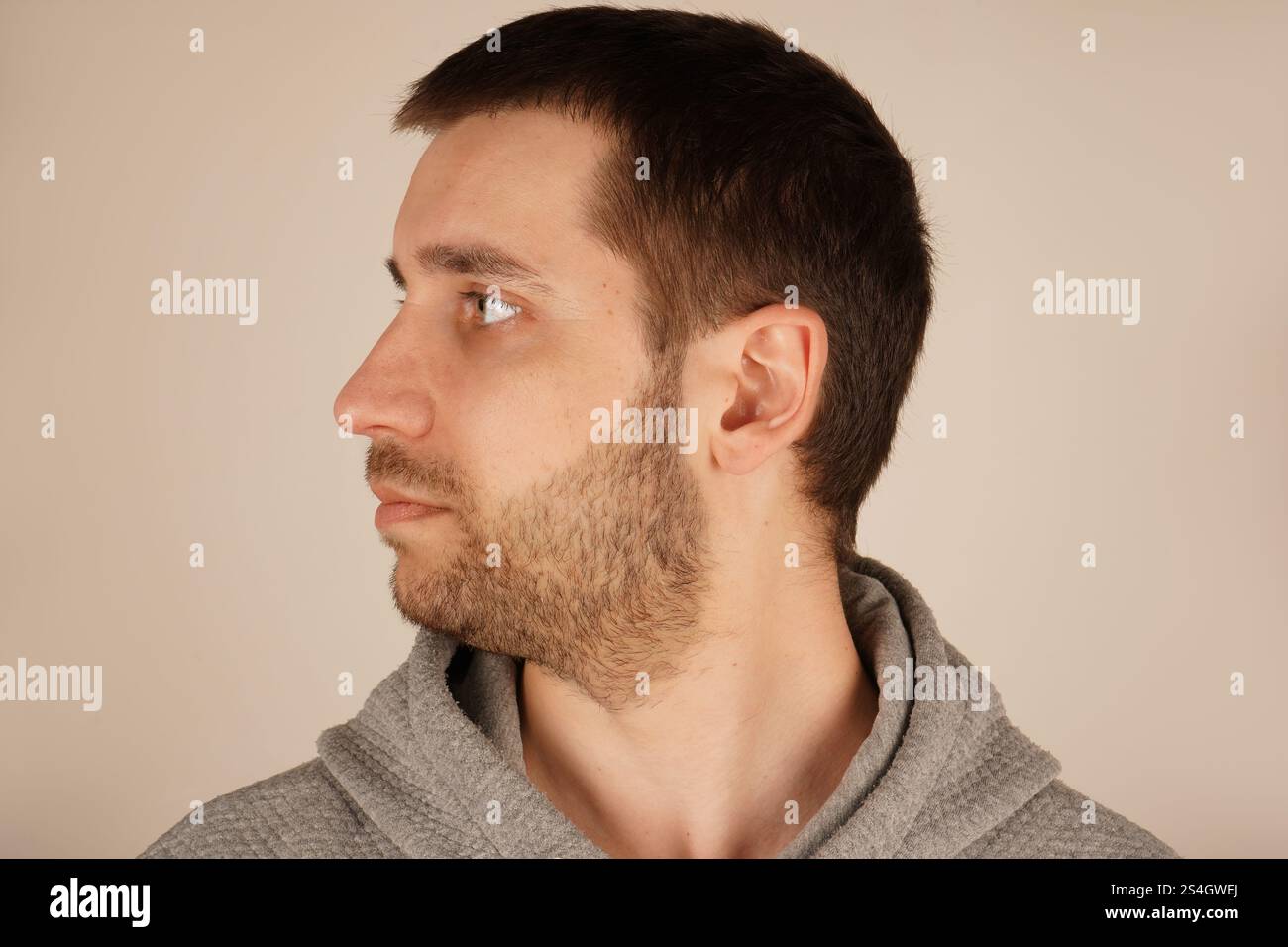 A man s calm head is shown in this close-up shot. His composed ...