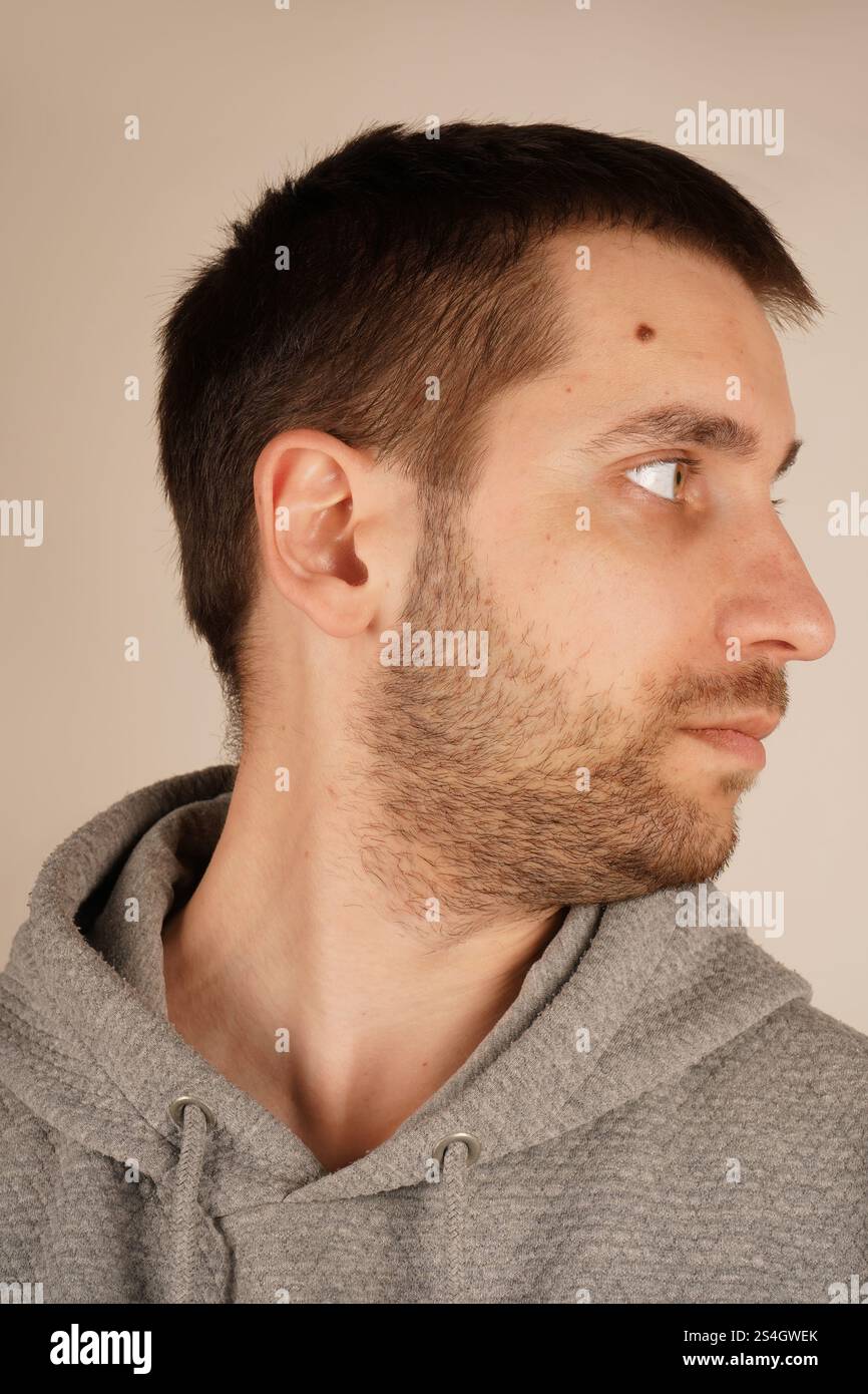 A man s calm head is shown in this close-up shot. His composed ...