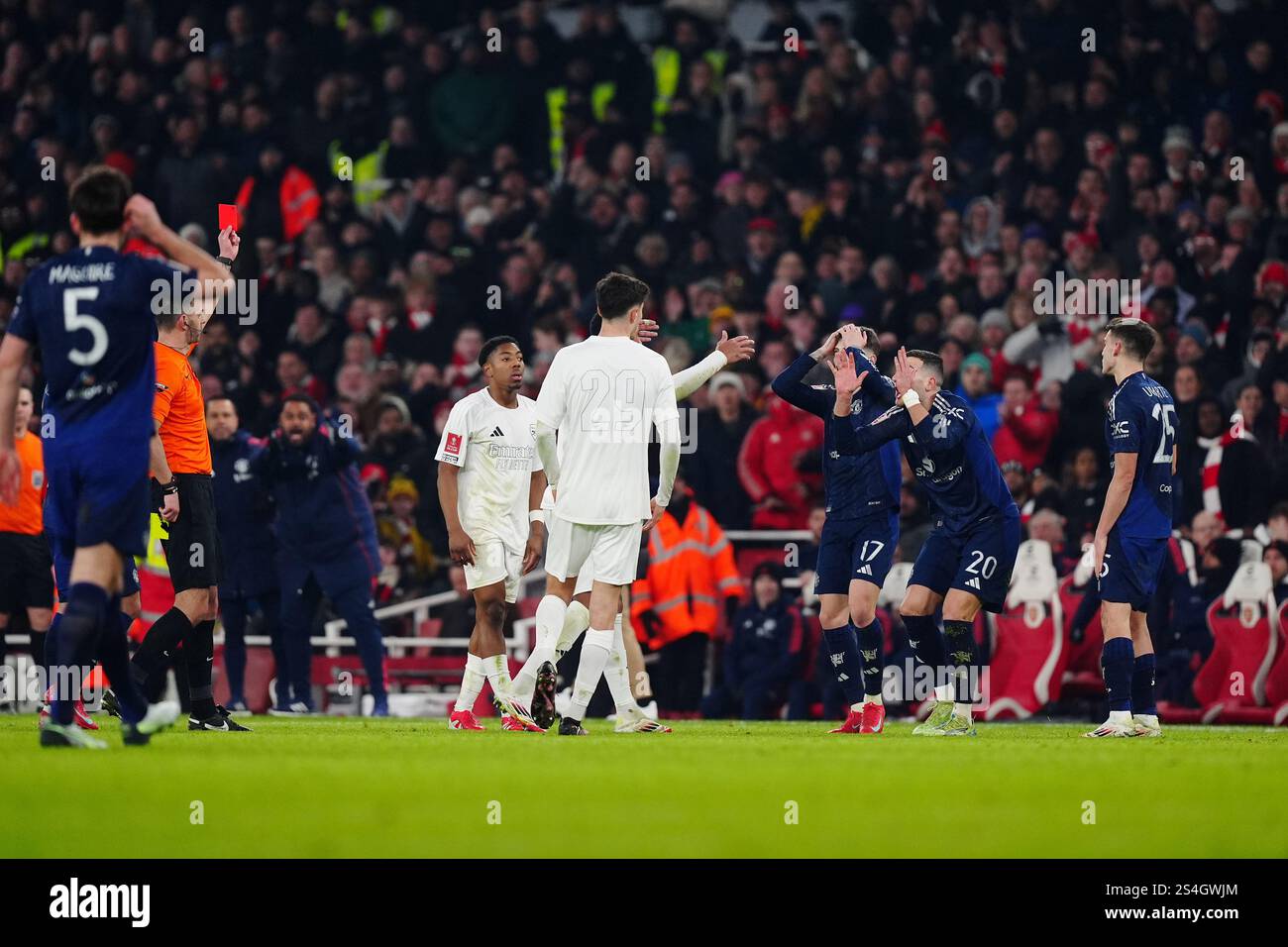 Manchester United's Diogo Dalot is shown a red card by referee Andrew ...