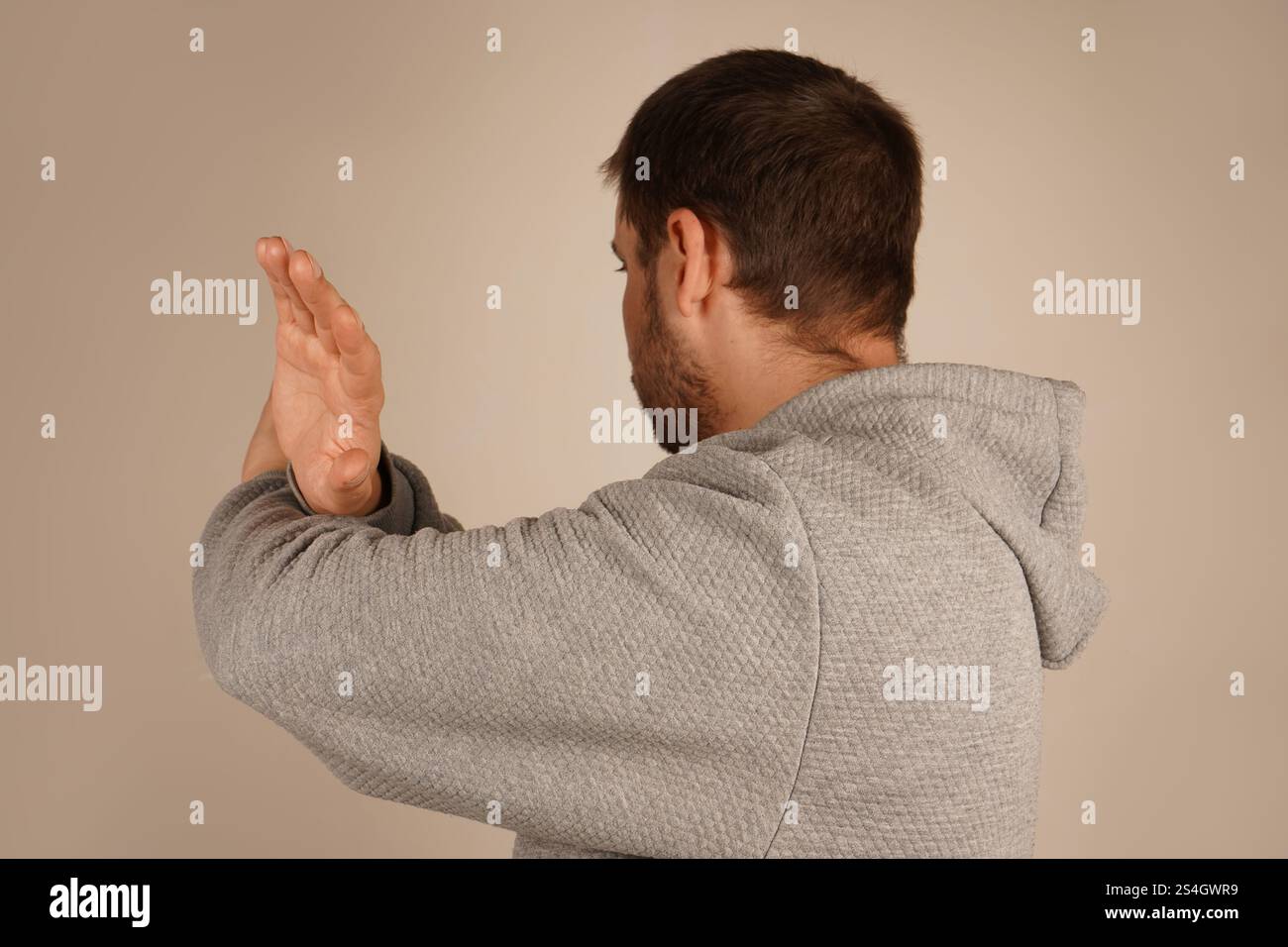 His open palms emphasize a defensive and assertive position. The image ...