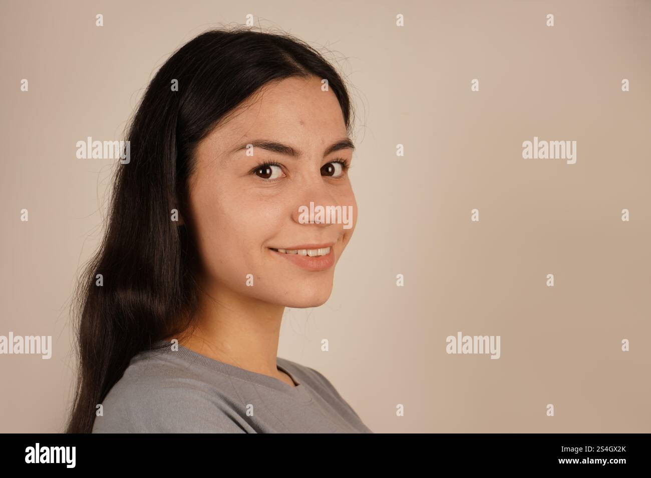 A close-up of a woman's face showcases her calm and relaxed demeanor ...