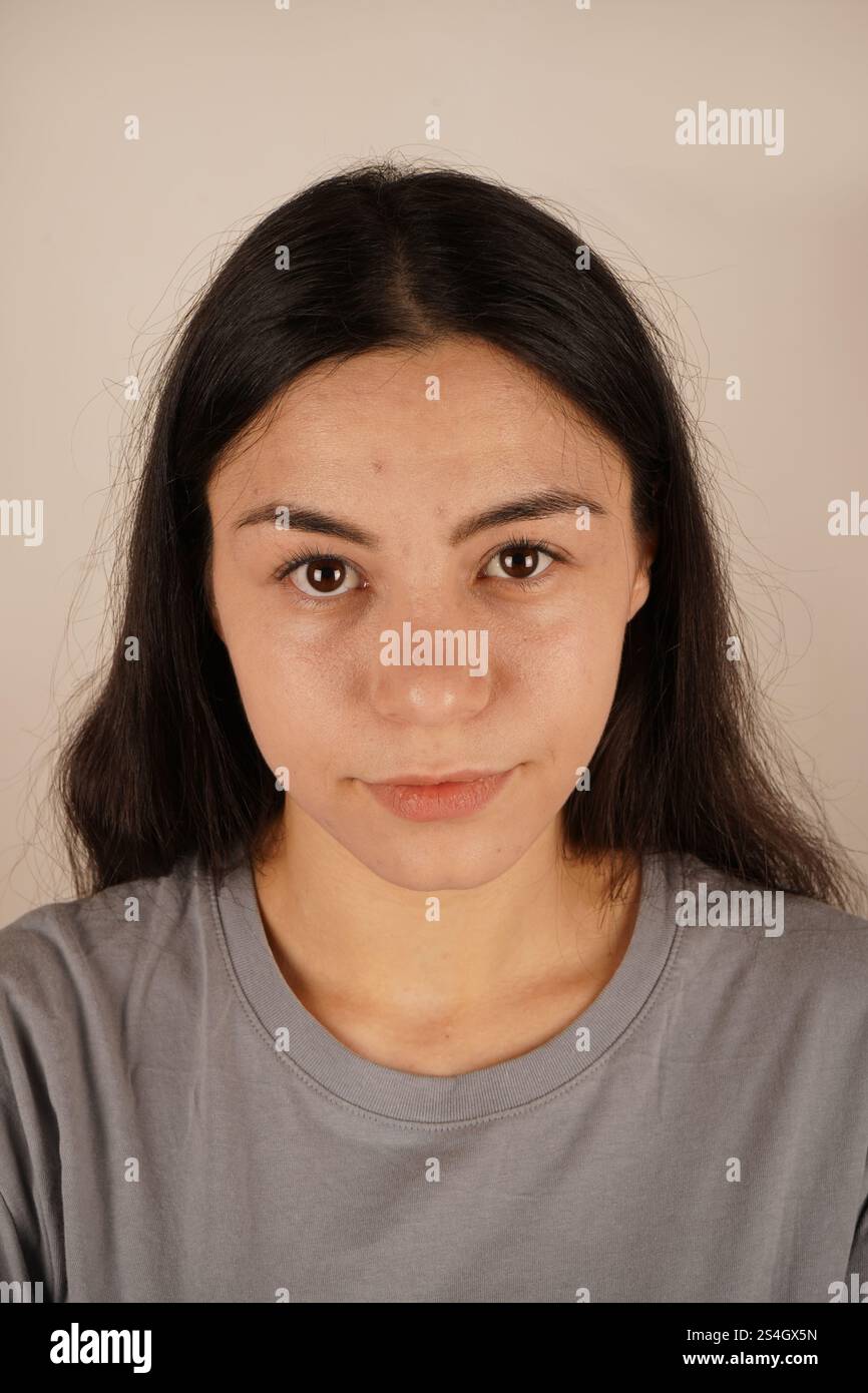 A close-up of a woman's face showcases her calm and relaxed demeanor ...