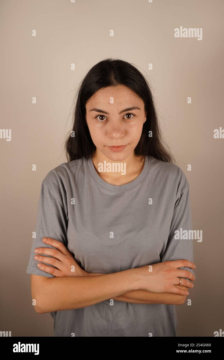 With hands layered, the woman emanates a sense of purpose and self ...