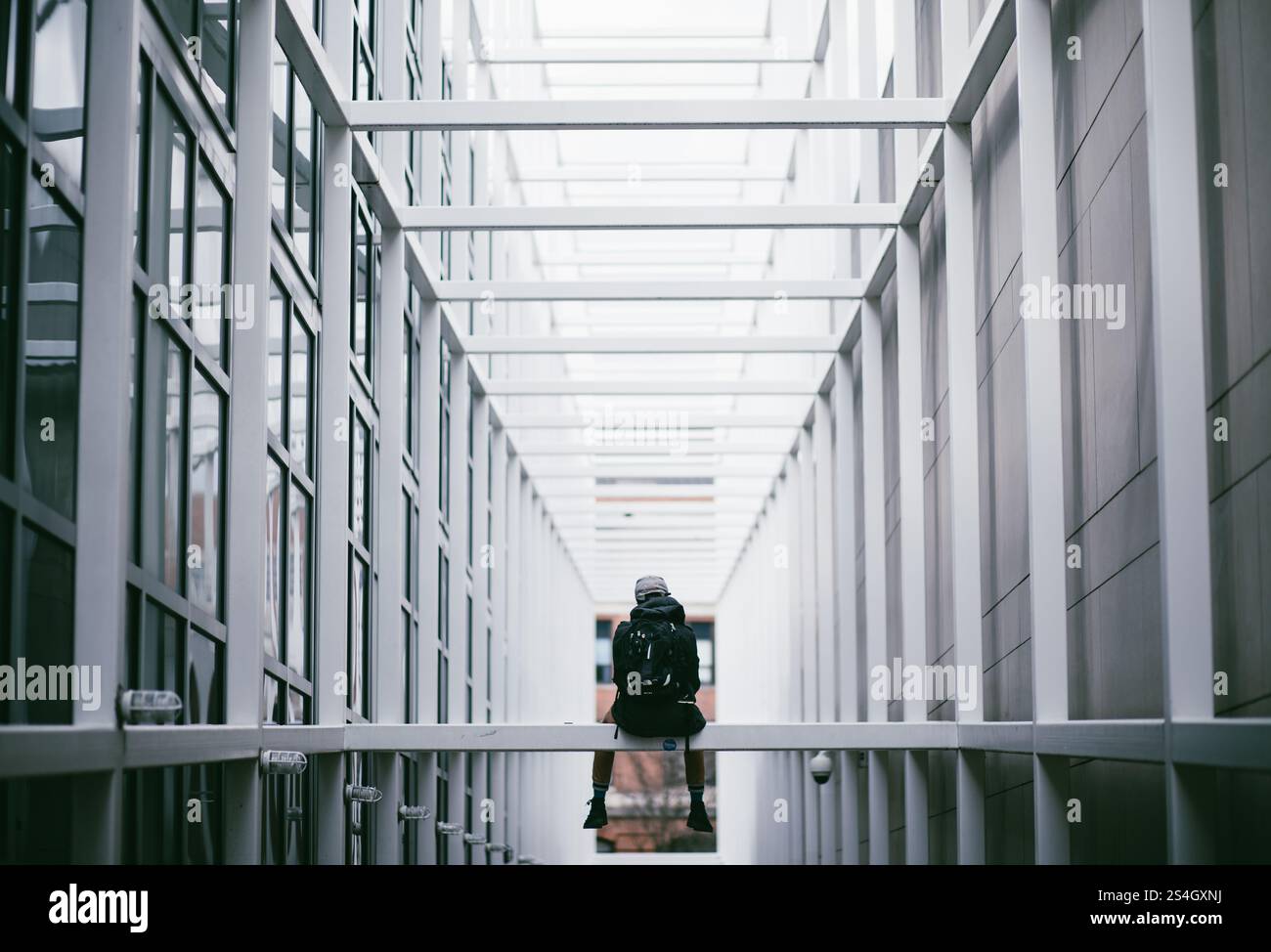 Modern Architectural Walkway with a Solitary Figure Stock Photo - Alamy